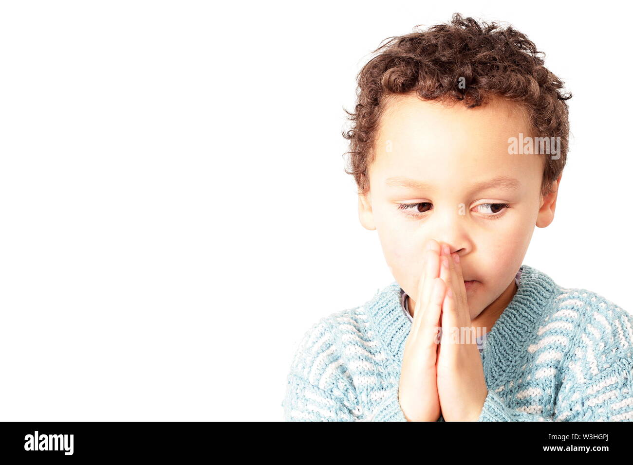 little boy praying to God and being religious stock image with hands ...