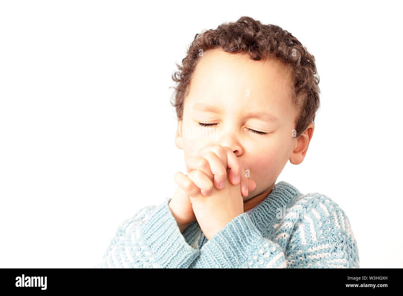 little boy praying to God and being religious stock image with hands ...