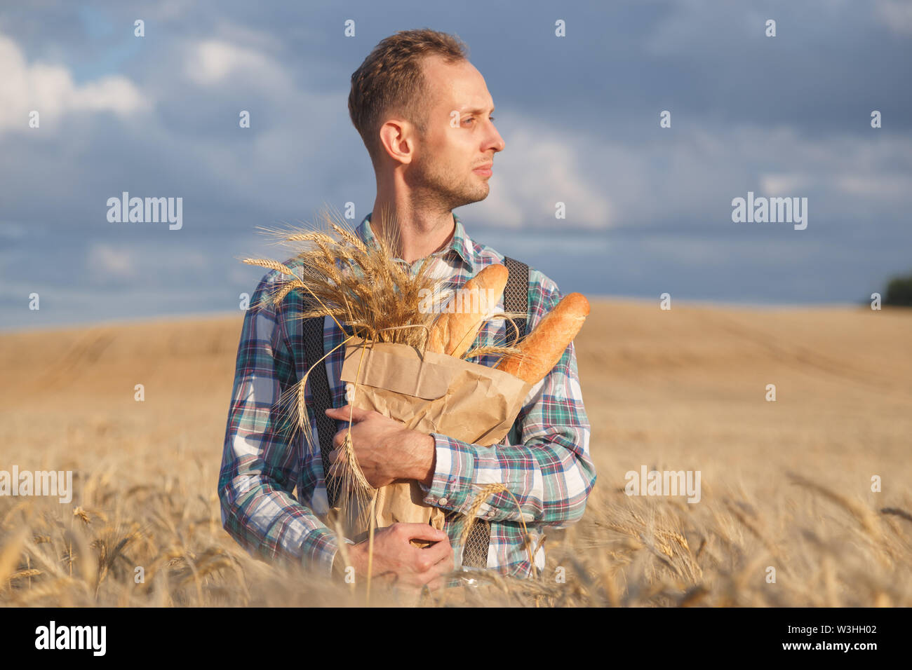 Male farmer or baker with baguettes in rye, wheat field Stock Photo - Alamy
