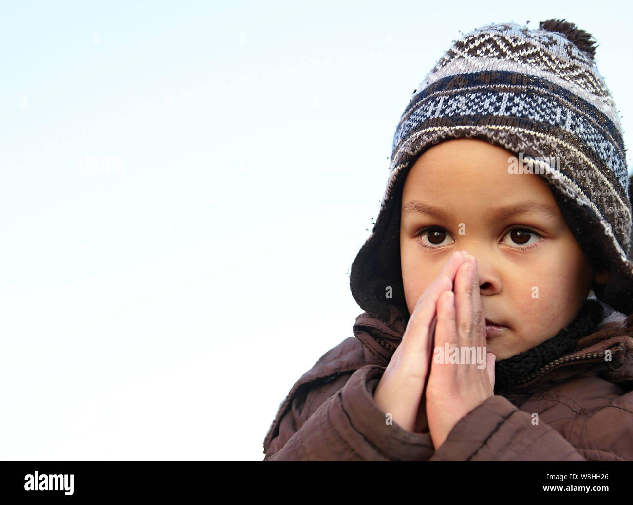 little boy praying to God and being religious stock image with hands ...