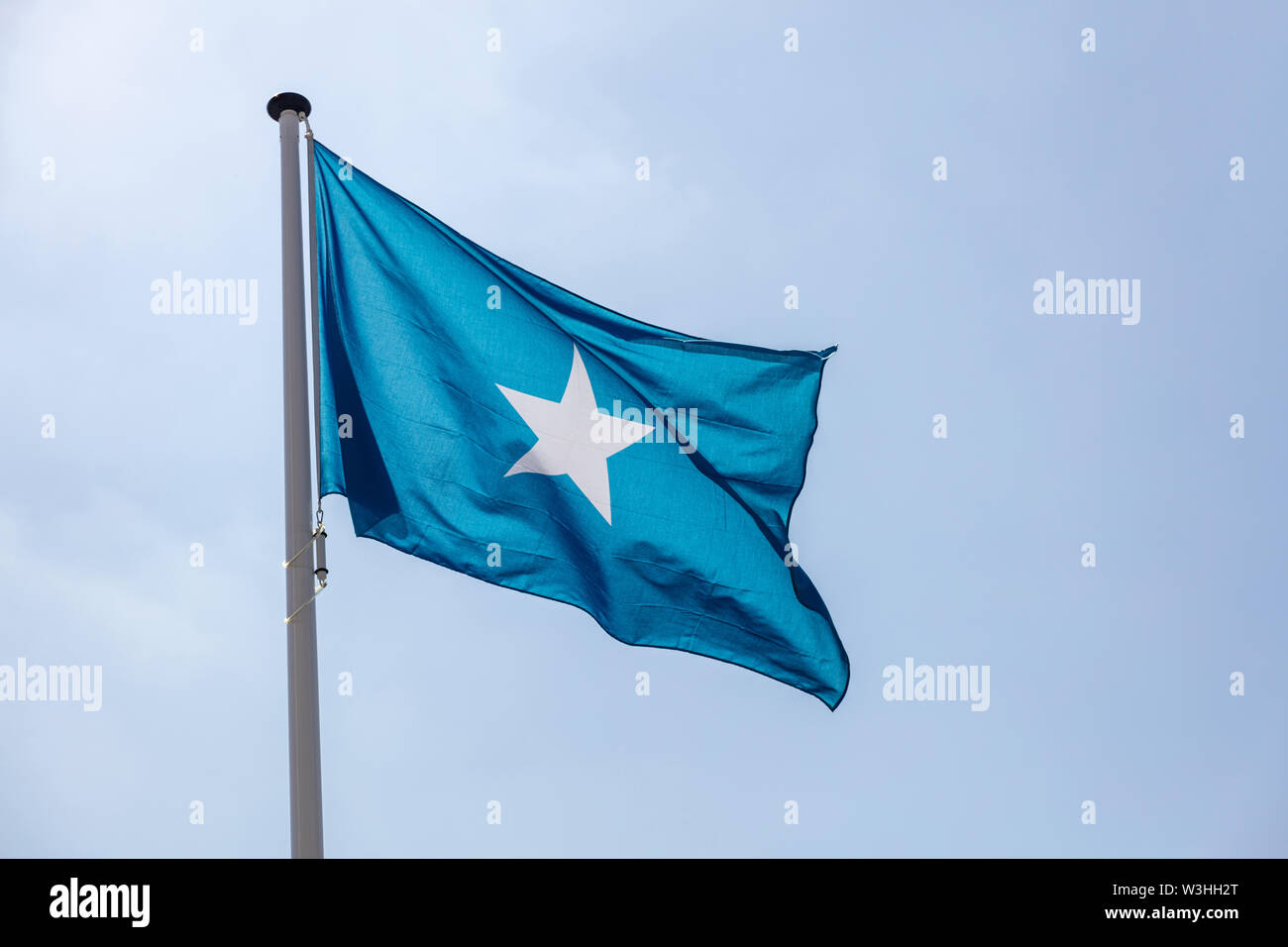 Somalia flag, National symbol waving against clear blue sky, sunny day ...