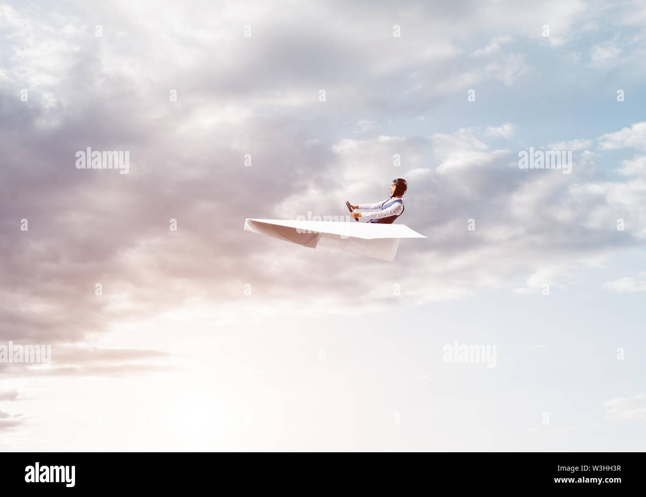 Aviator having fun in aircraft. Pilot in leather helmet and goggles ...