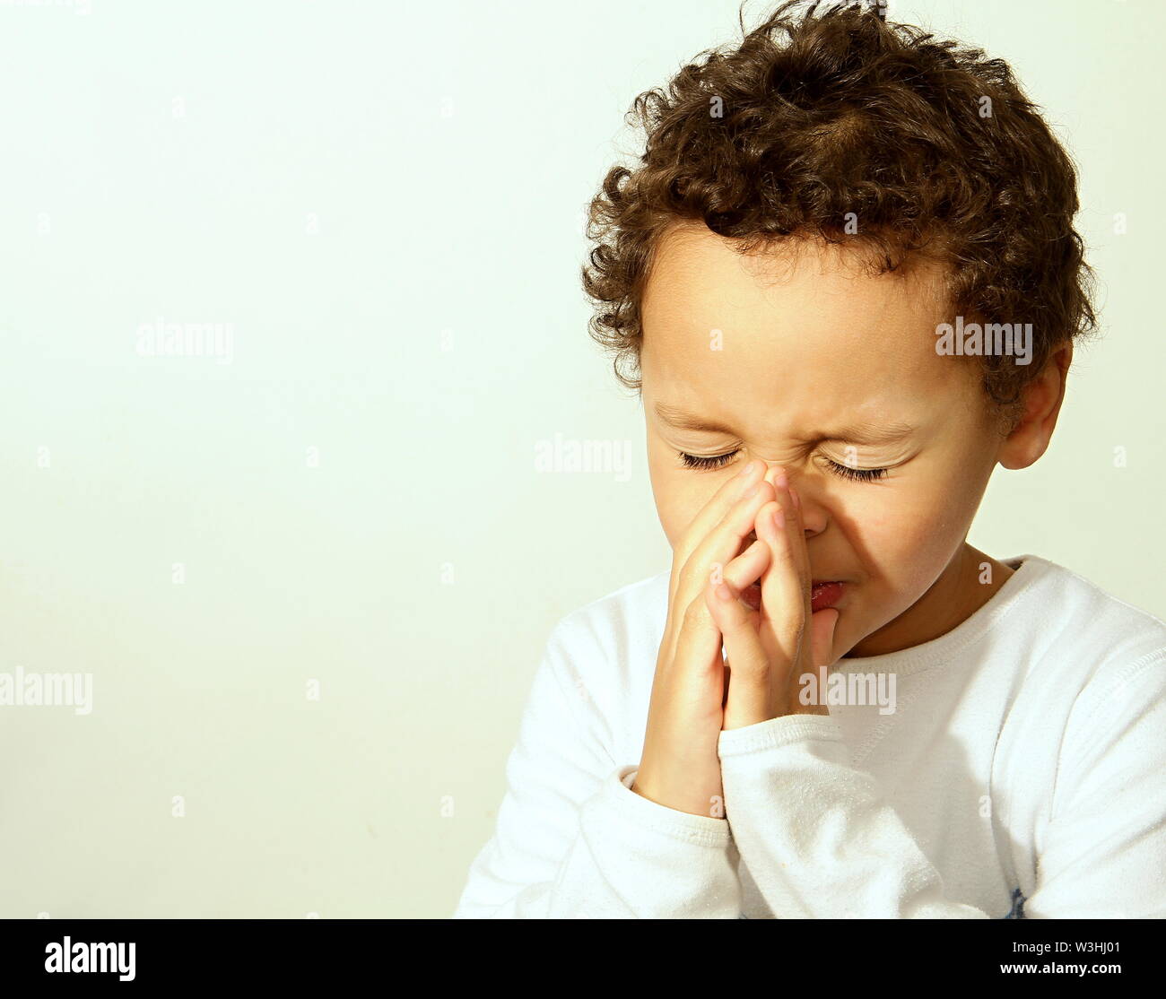 little boy praying to God and being religious stock image with hands ...