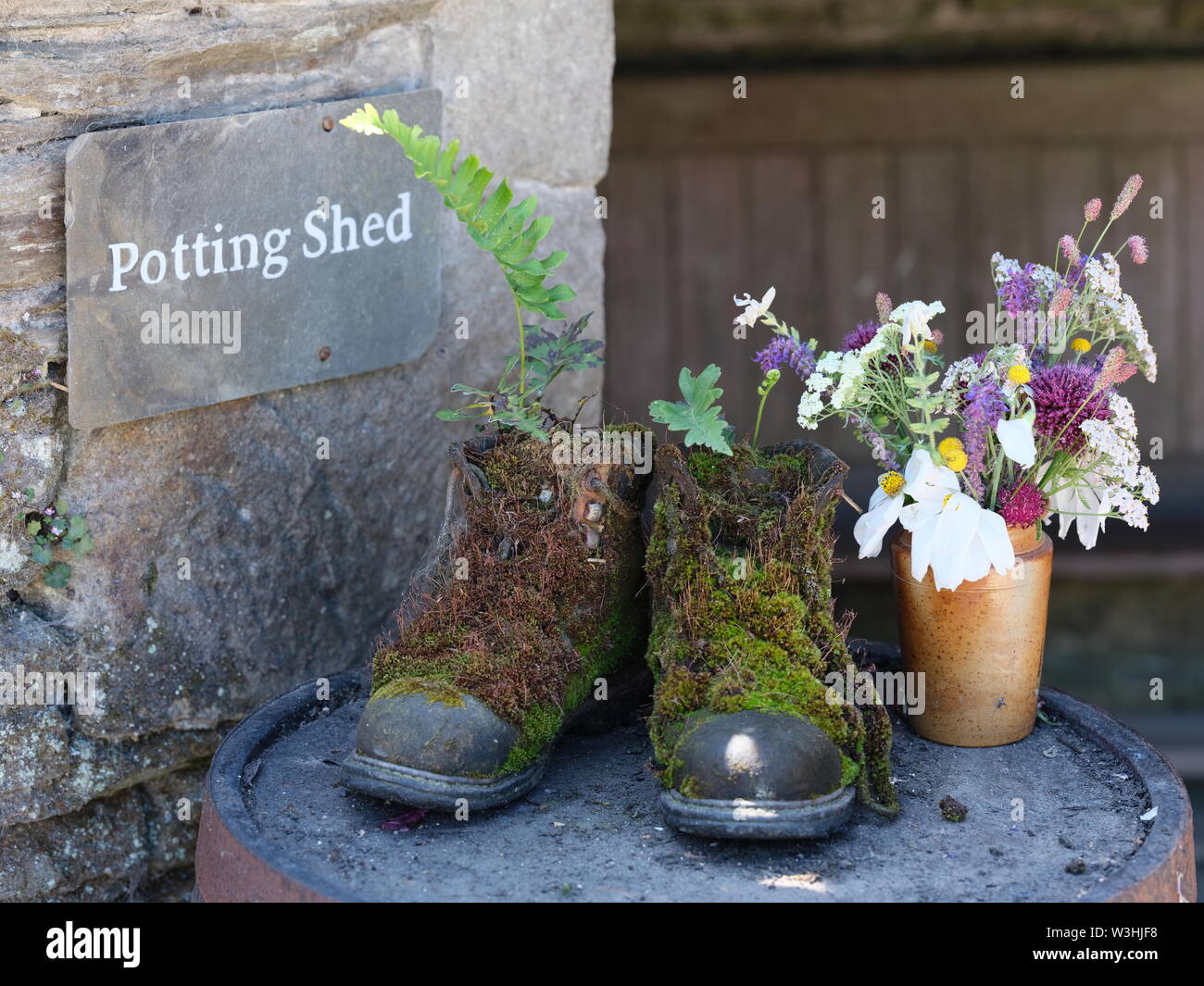 The Potting Shed boots slate sign and vase of flowers The Lost Gardens ...