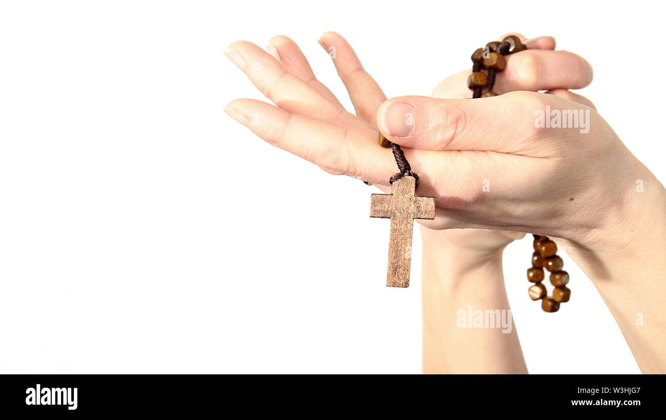 woman praying hand together reaching out with a crucifix and rosary ...