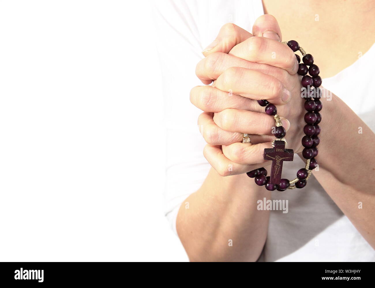 woman praying hand together reaching out with a crucifix and rosary ...