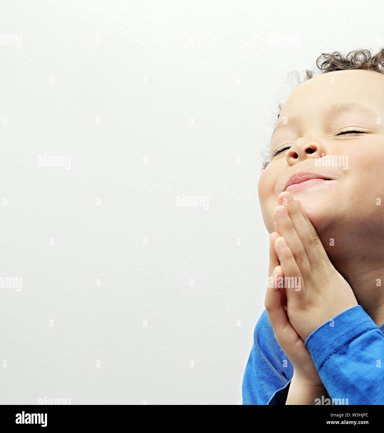 little boy praying to God with hands together stock photo Stock Photo ...