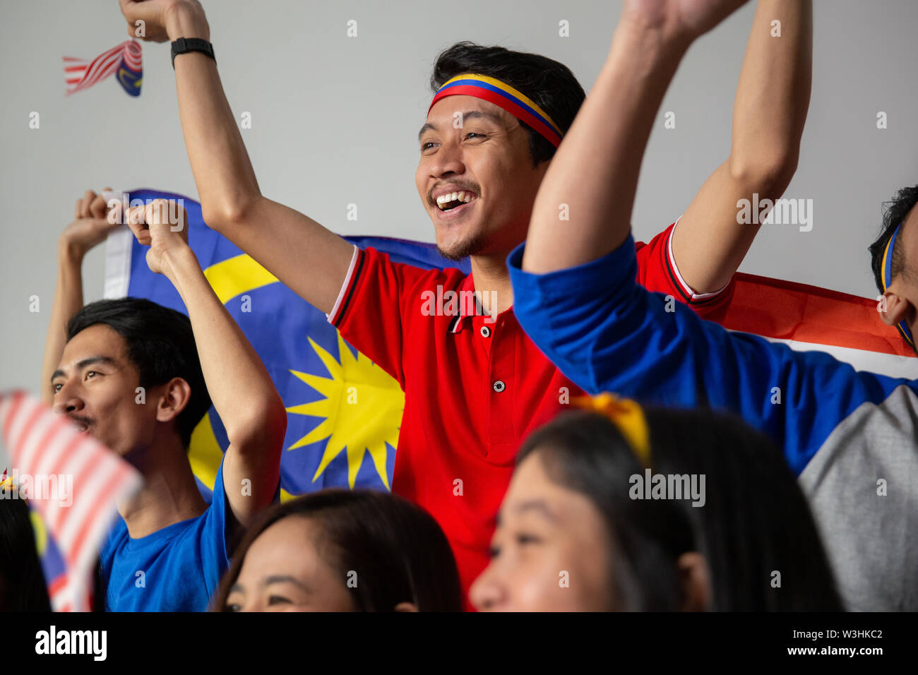 malay group of people holding malaysia flag celebrating independence ...