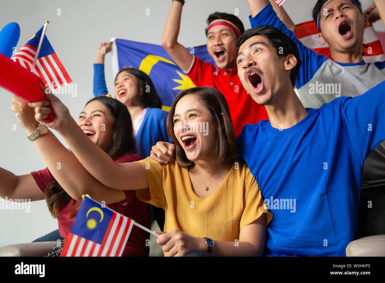 malay group of people holding malaysia flag celebrating independence ...