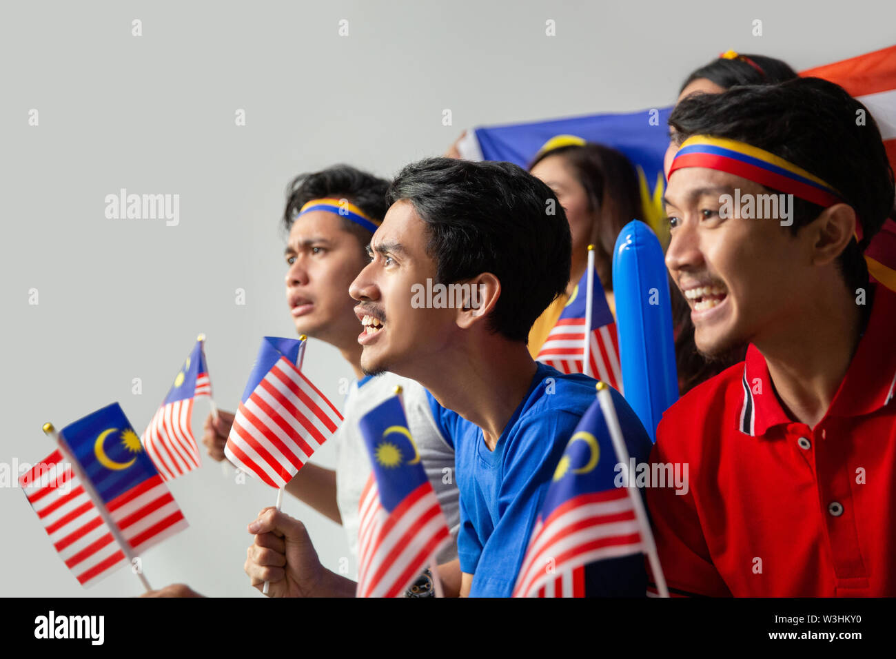malay group of people holding malaysia flag celebrating independence ...