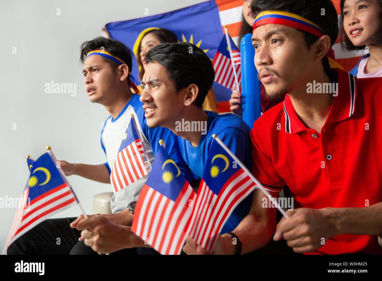 malay group of people holding malaysia flag celebrating independence ...