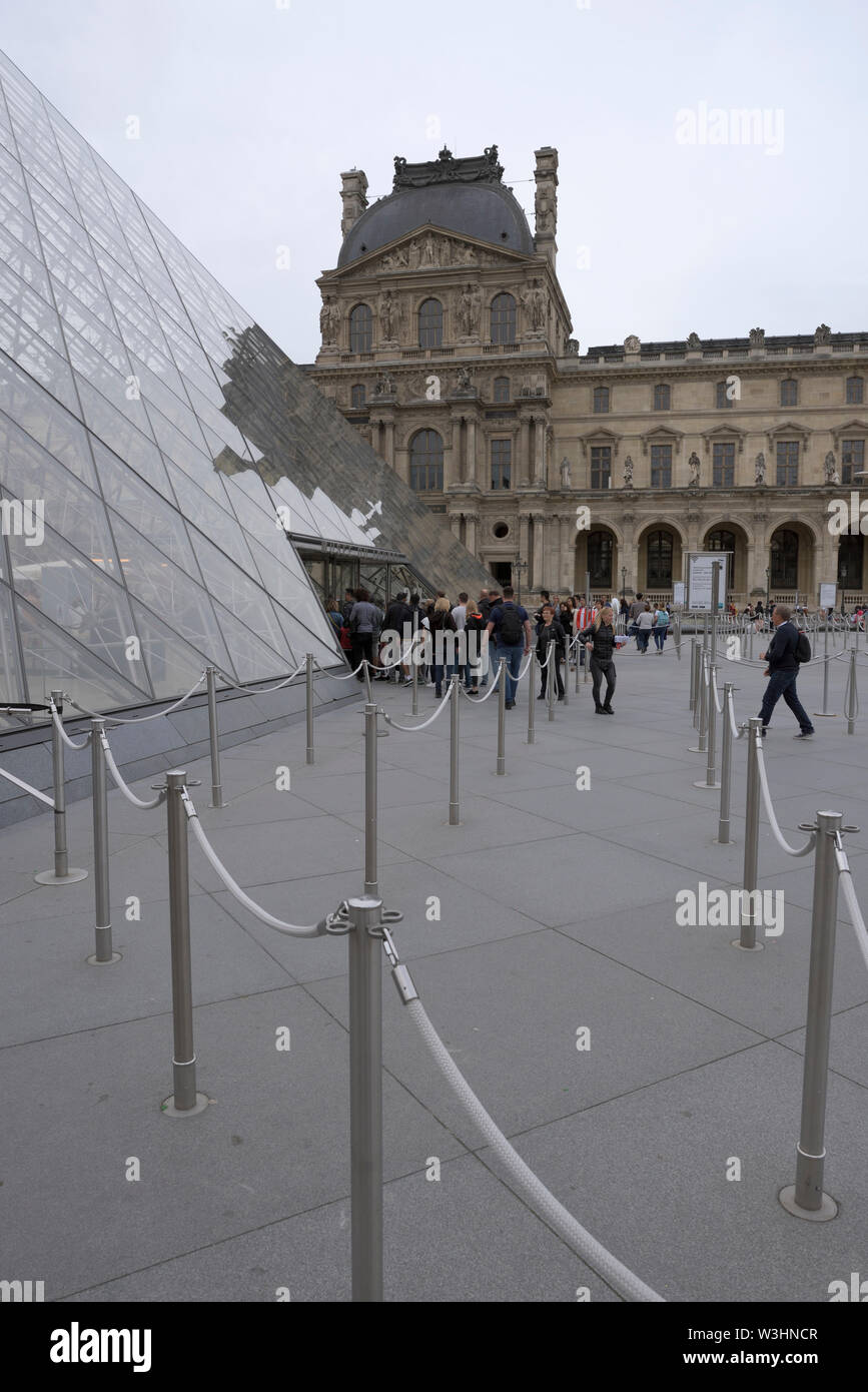 short line at the entrance to the Louvre museum at the glass pyramide ...