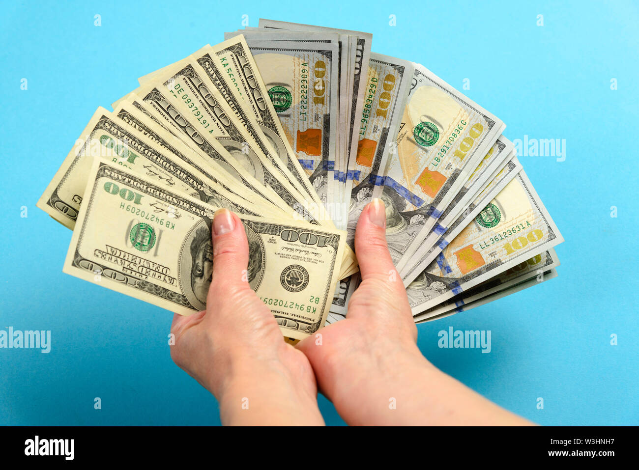 100 Dollar Bills In Hand