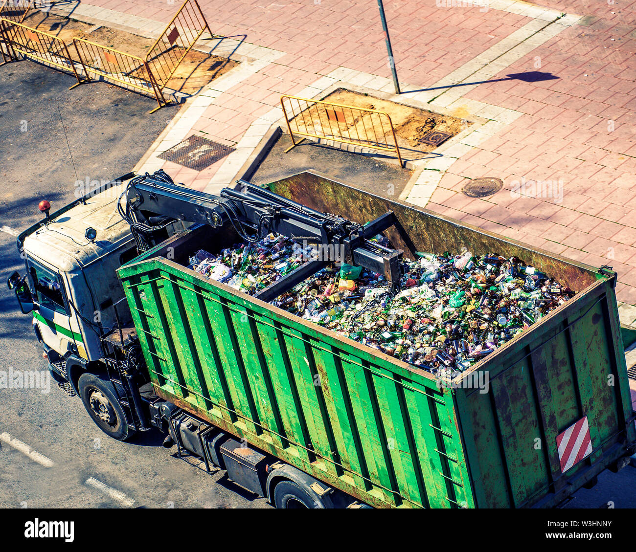 top view of green truck collecting glass for recycling in the city ...