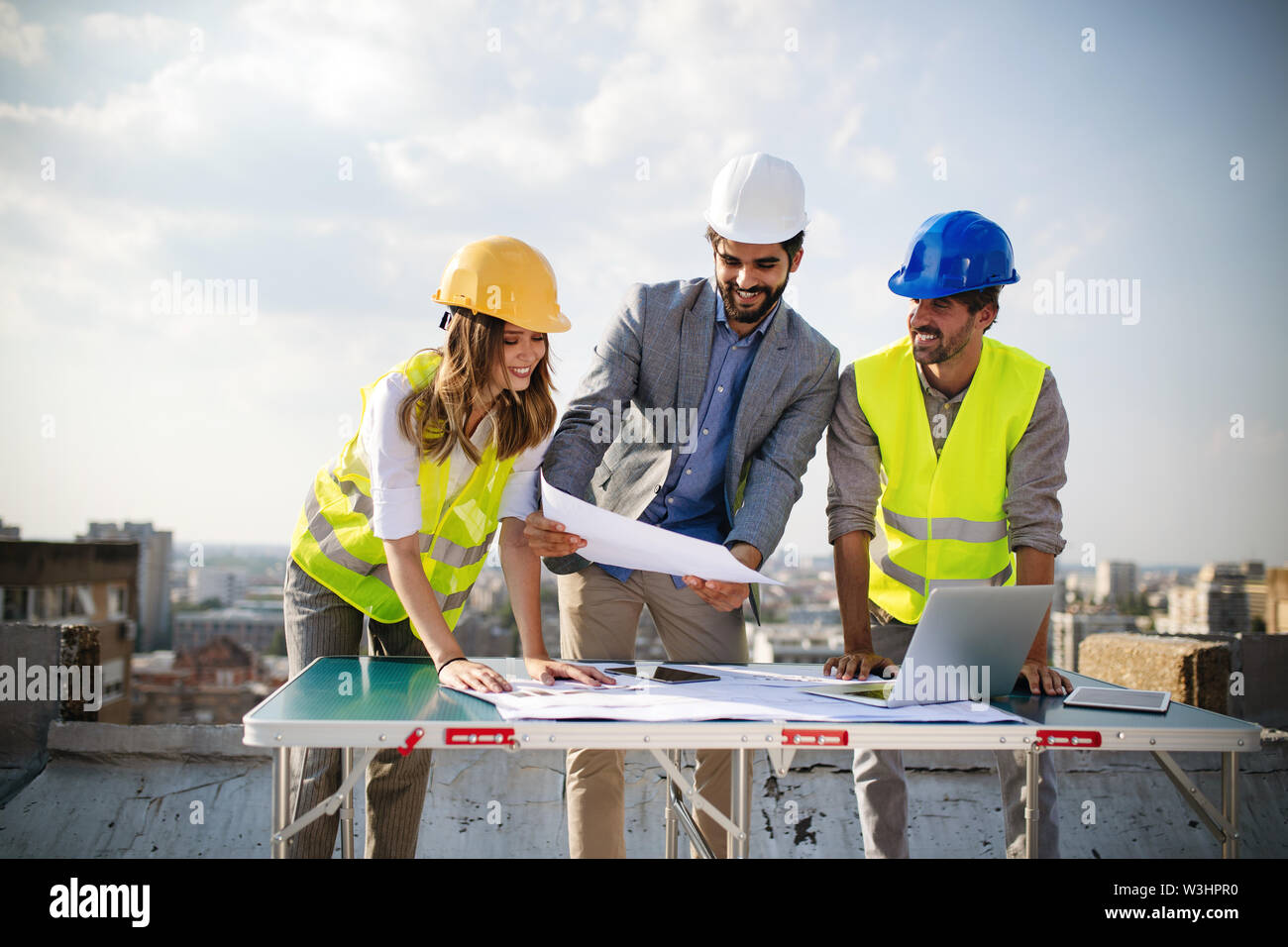 Team of architects people in group on construciton site check documents ...