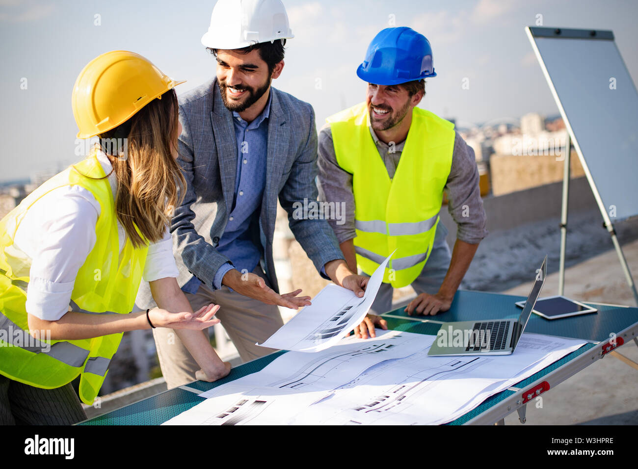 Group of engineers, architects, business partners at construction site ...