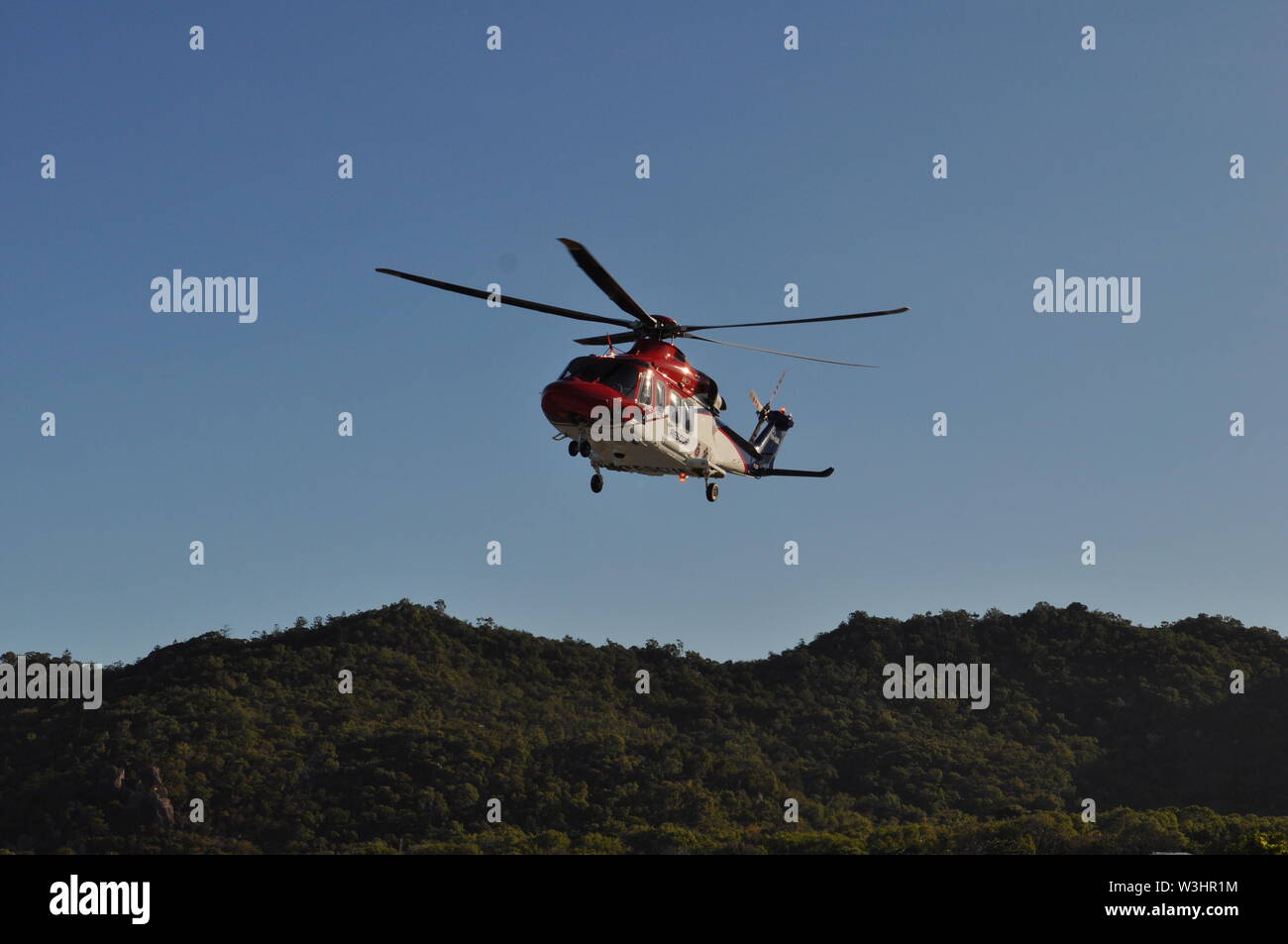 Rescue helicopter, in an emergency, collecting a patient from Nelly Bay ...
