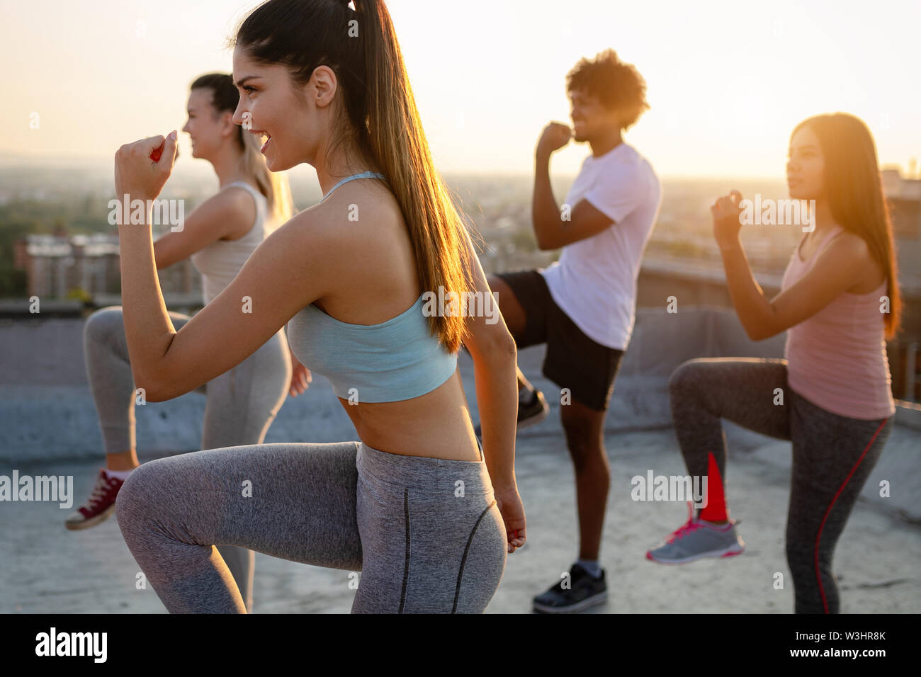 Group of happy fit friends exercising outdoor in city Stock Photo - Alamy