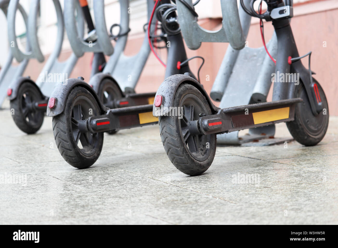 Electric scooters parked on a city street. Self-service transport ...