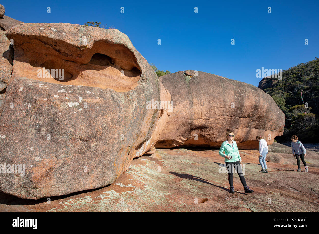 Sleepy Bay Tasmania, mother with two teenage girls explore the massive ...