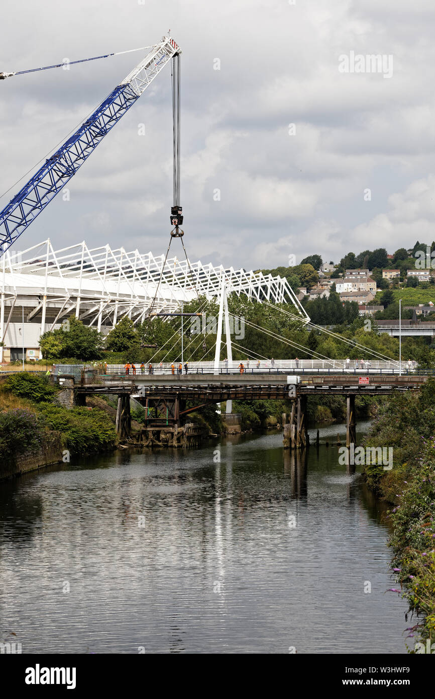 Pictured: A crane prepares to lift the Bascule Bridge over river Tawe ...