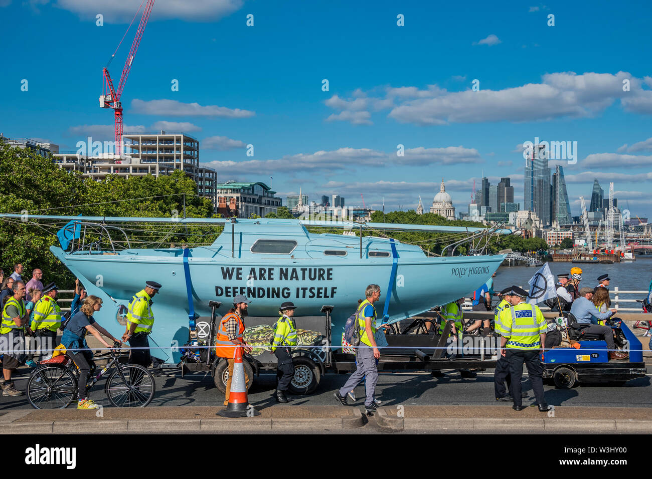 London, UK. 15th July 2019. The boat is towed over Waterloo Bridge by ...