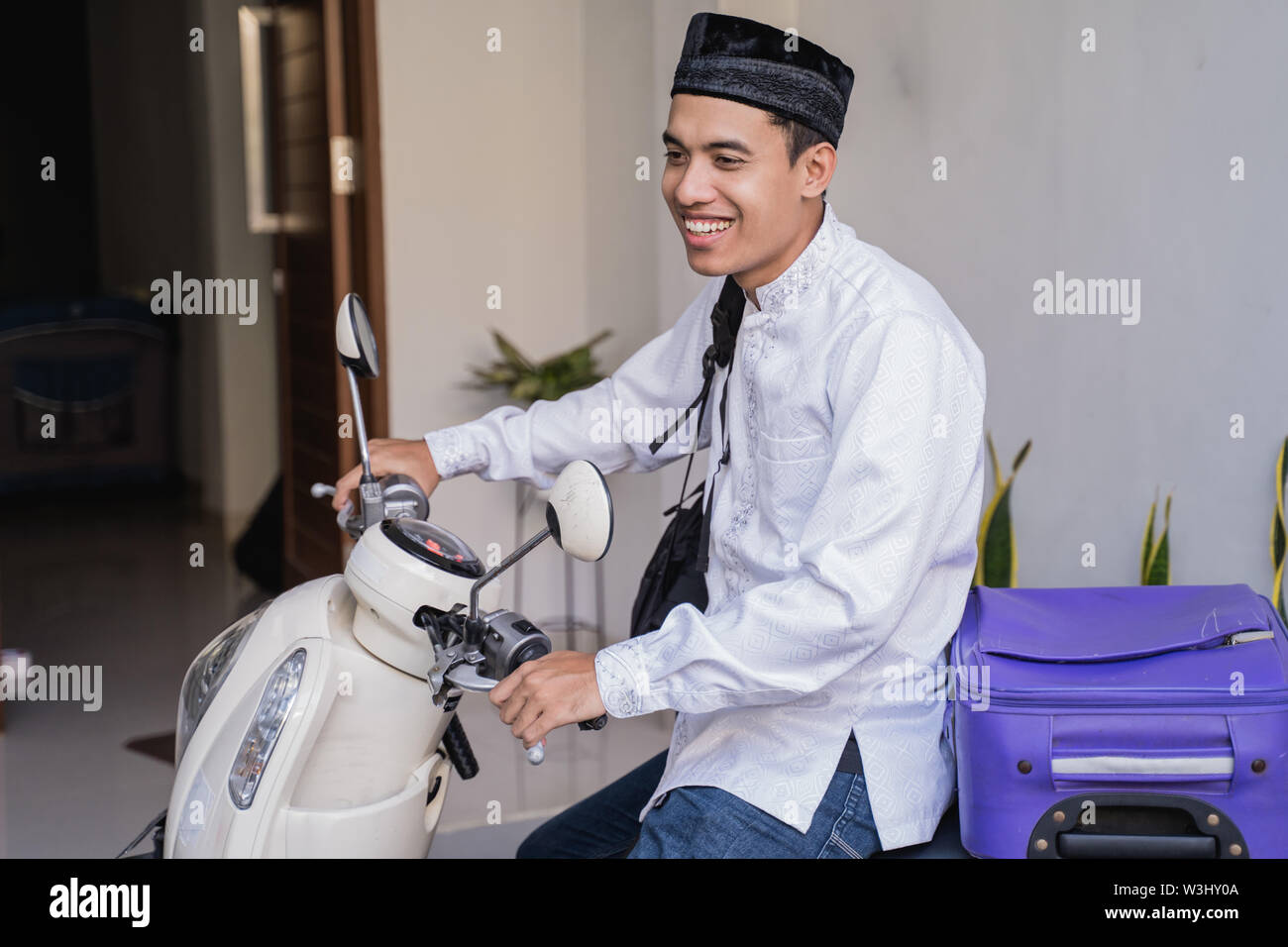 happy muslim man ride motorcycle for idul fitri balik kampung mudik ...