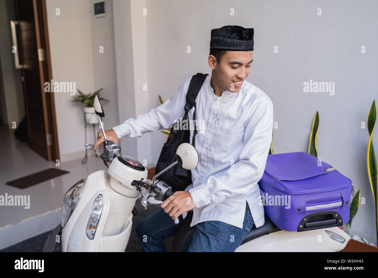 happy muslim man ride motorcycle for idul fitri balik kampung mudik ...