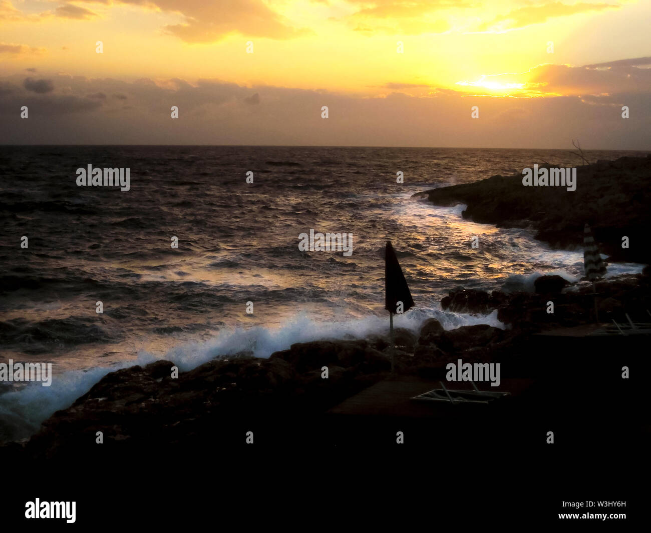 Yellow sky, sea, waves and sunset. Cala delle Roselle at the Tremiti ...