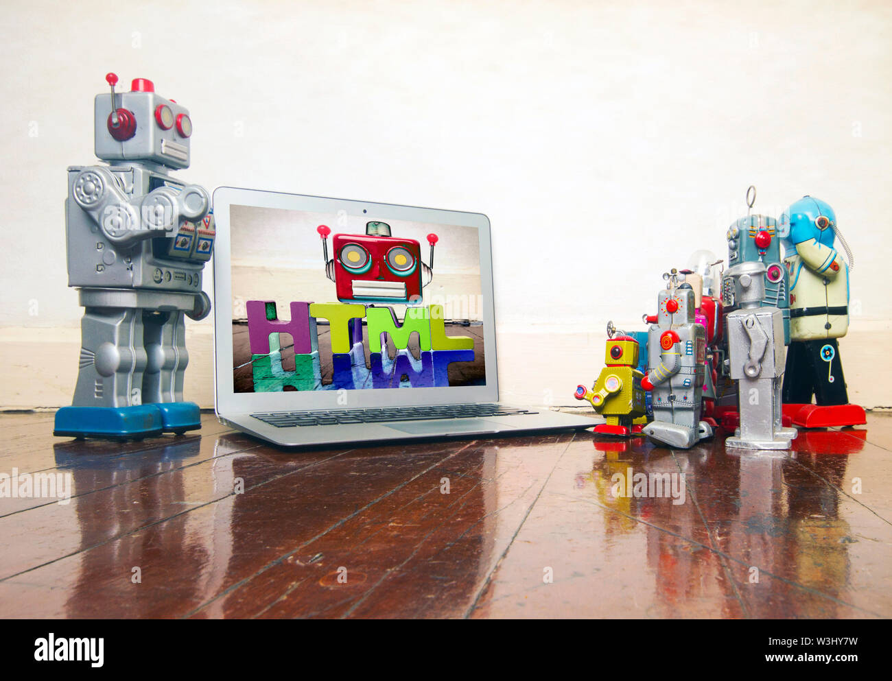 silver robot teaching about code to kid robot toys Stock Photo - Alamy