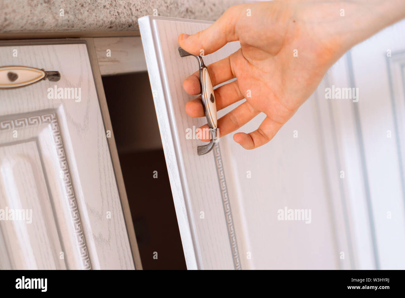 close up person hand opens wooden shelf at home Stock Photo - Alamy