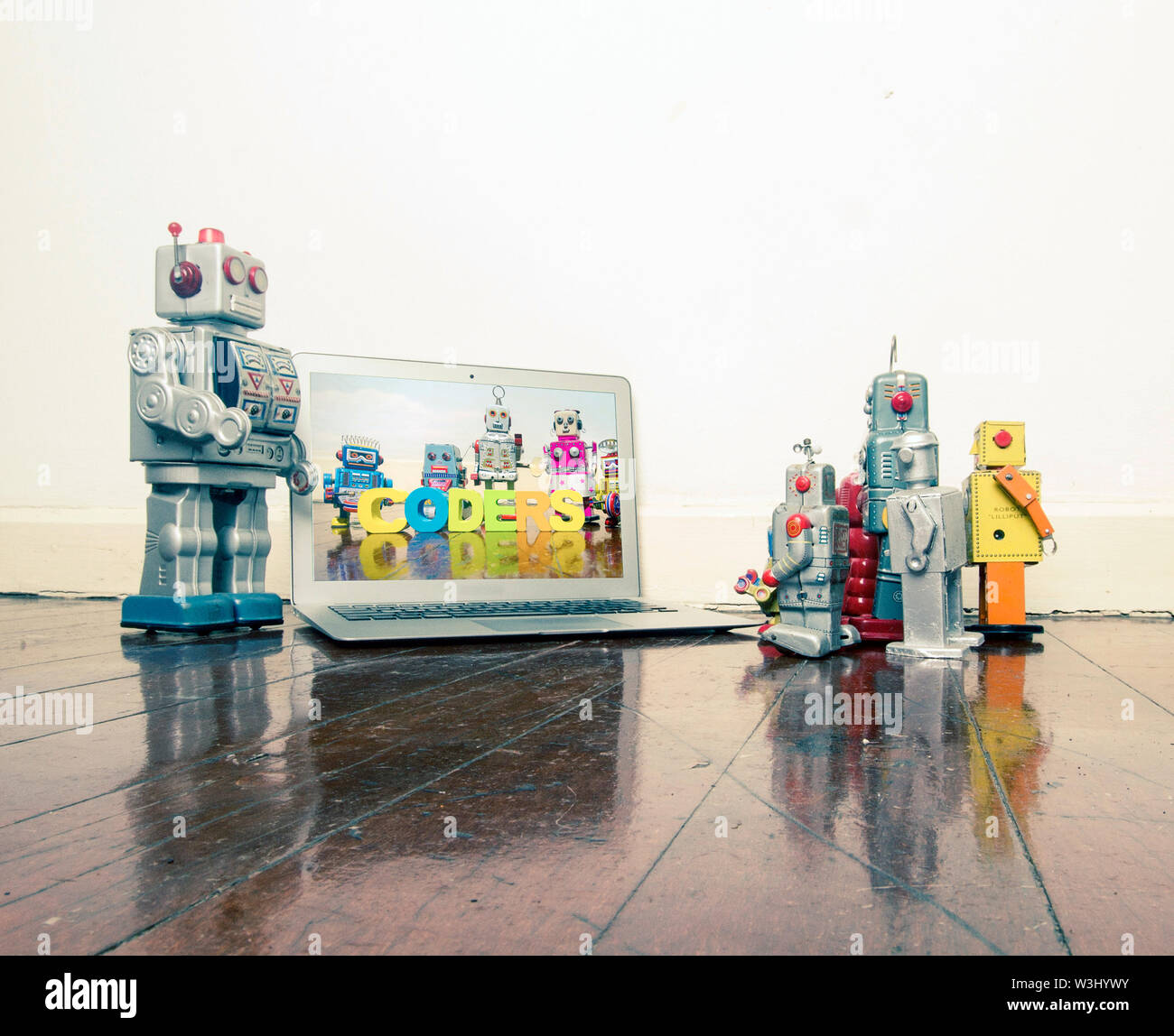 silver robot teaching about code to kid robot toys Stock Photo - Alamy