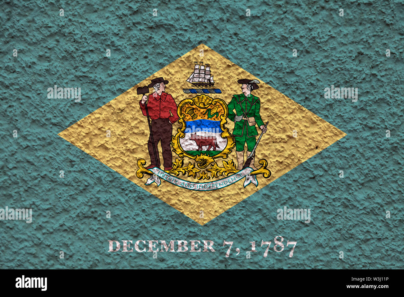 The national flag of the US state Delaware in against a gray wall with ...
