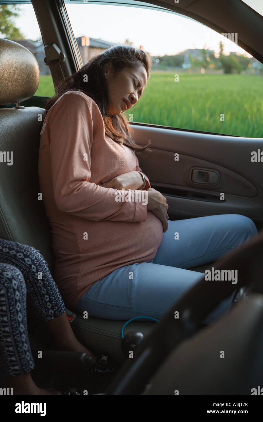 pregnant woman belly ache during trip on car holding her tummy Stock ...