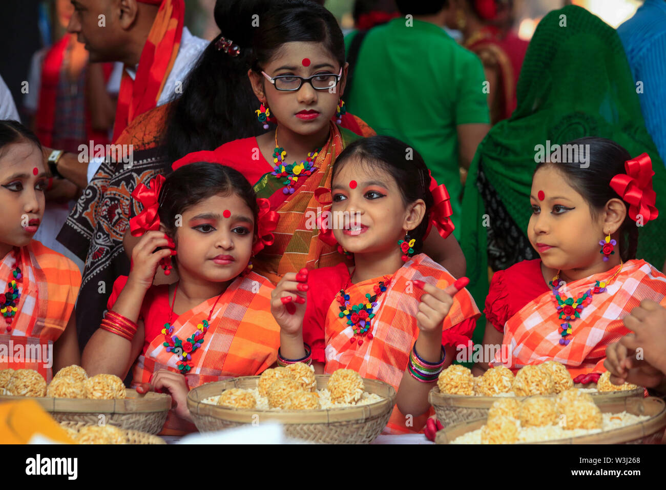 Young dancers offer the baskets of traditional sweet 'Moa' made of ...