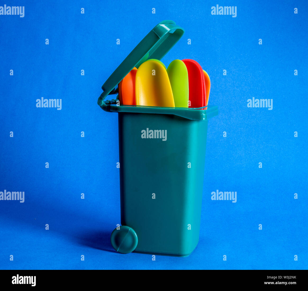 Regular recycling of plastics using a green wheelie bin Stock Photo - Alamy