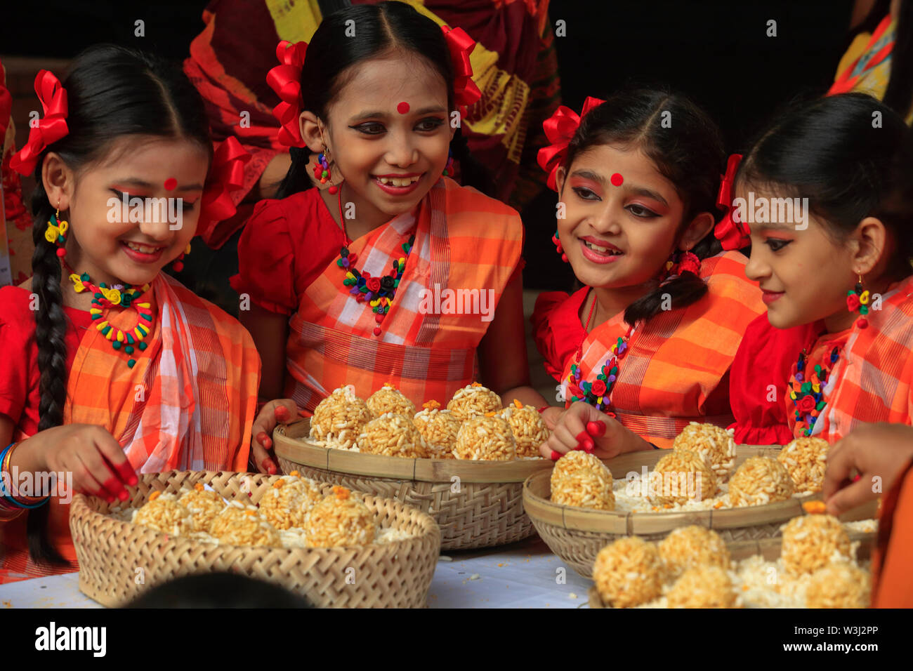 Young dancers offer the baskets of traditional sweet 'Moa' made of ...