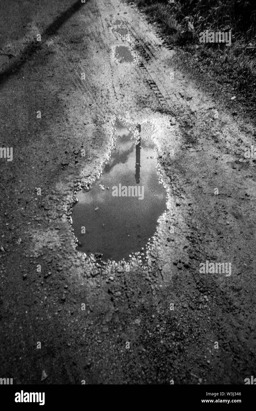 Pothole and puddle in road Black and White Stock Photos & Images - Alamy