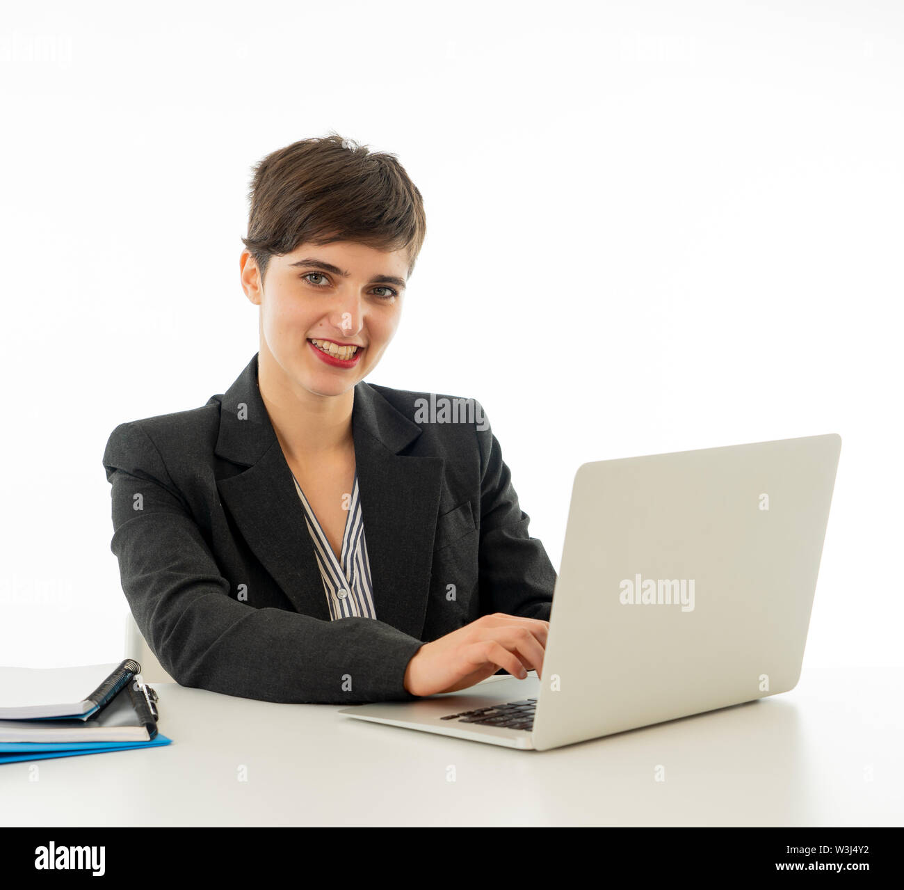 Happy, smiling and successful businesswoman working on computer laptop ...