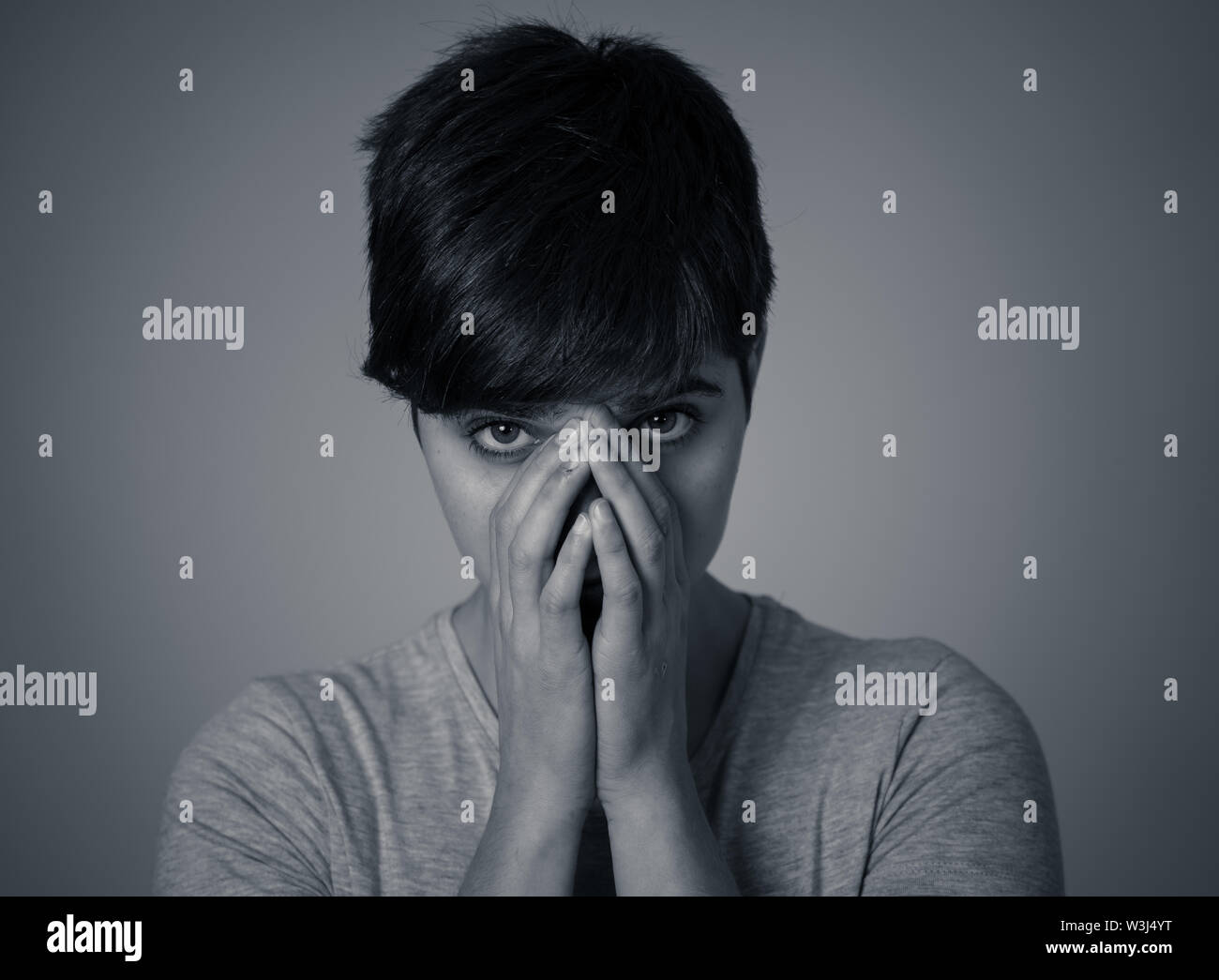 Black and white portrait of beautiful young woman looking sad and ...