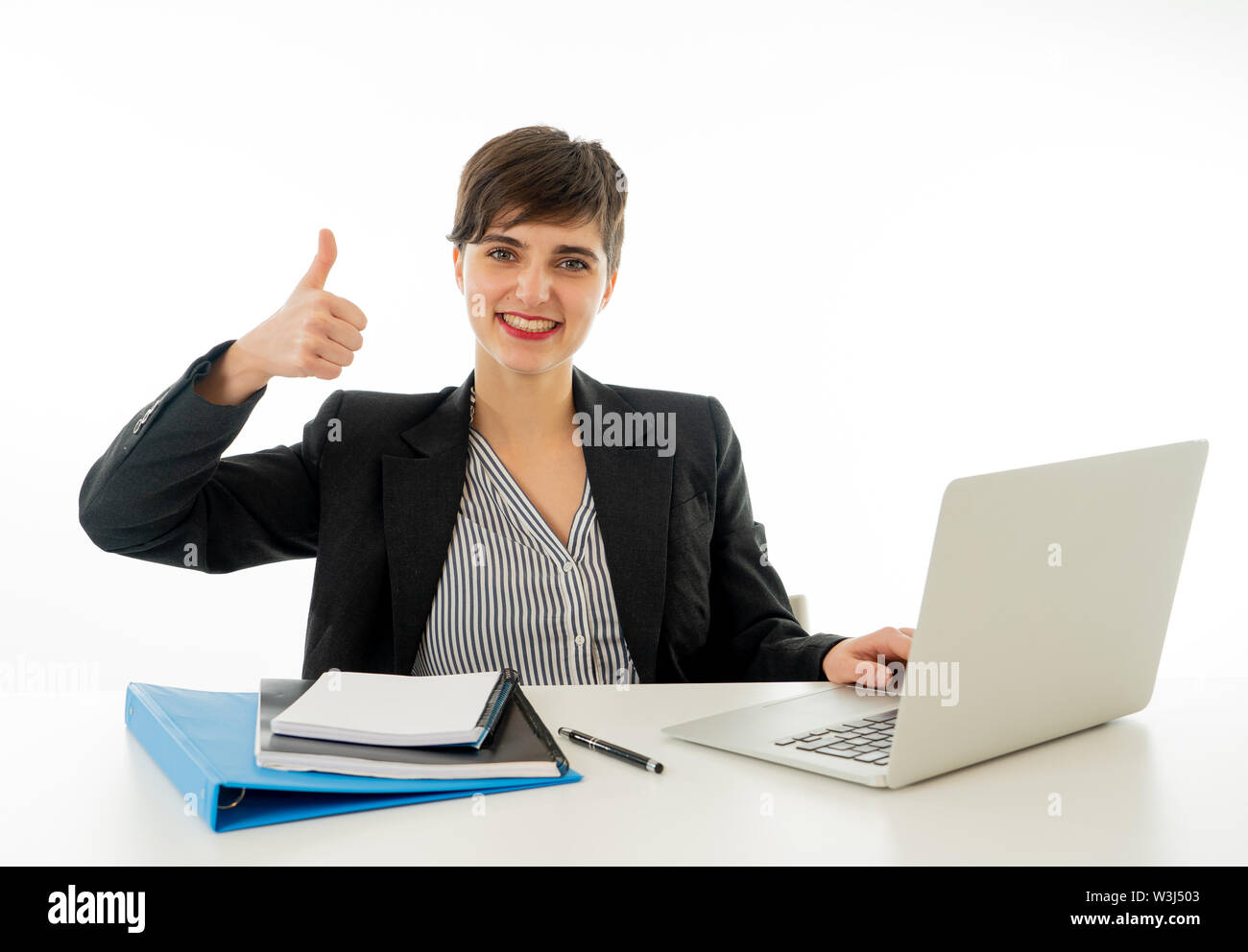 Happy, smiling and successful businesswoman working on computer laptop ...