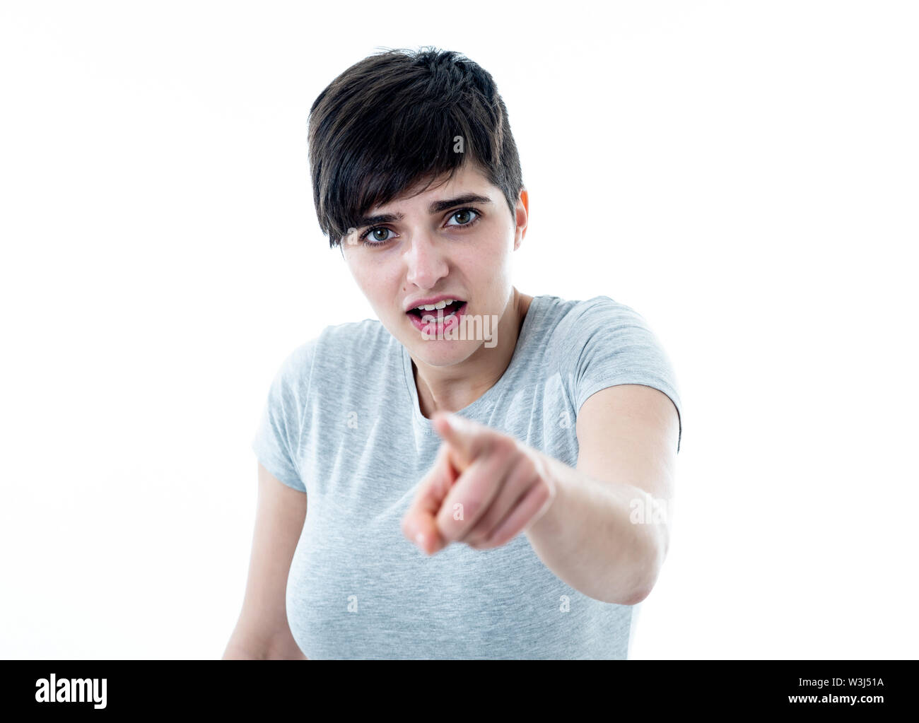 Close up portrait of scared and shocked young woman pointing at ...