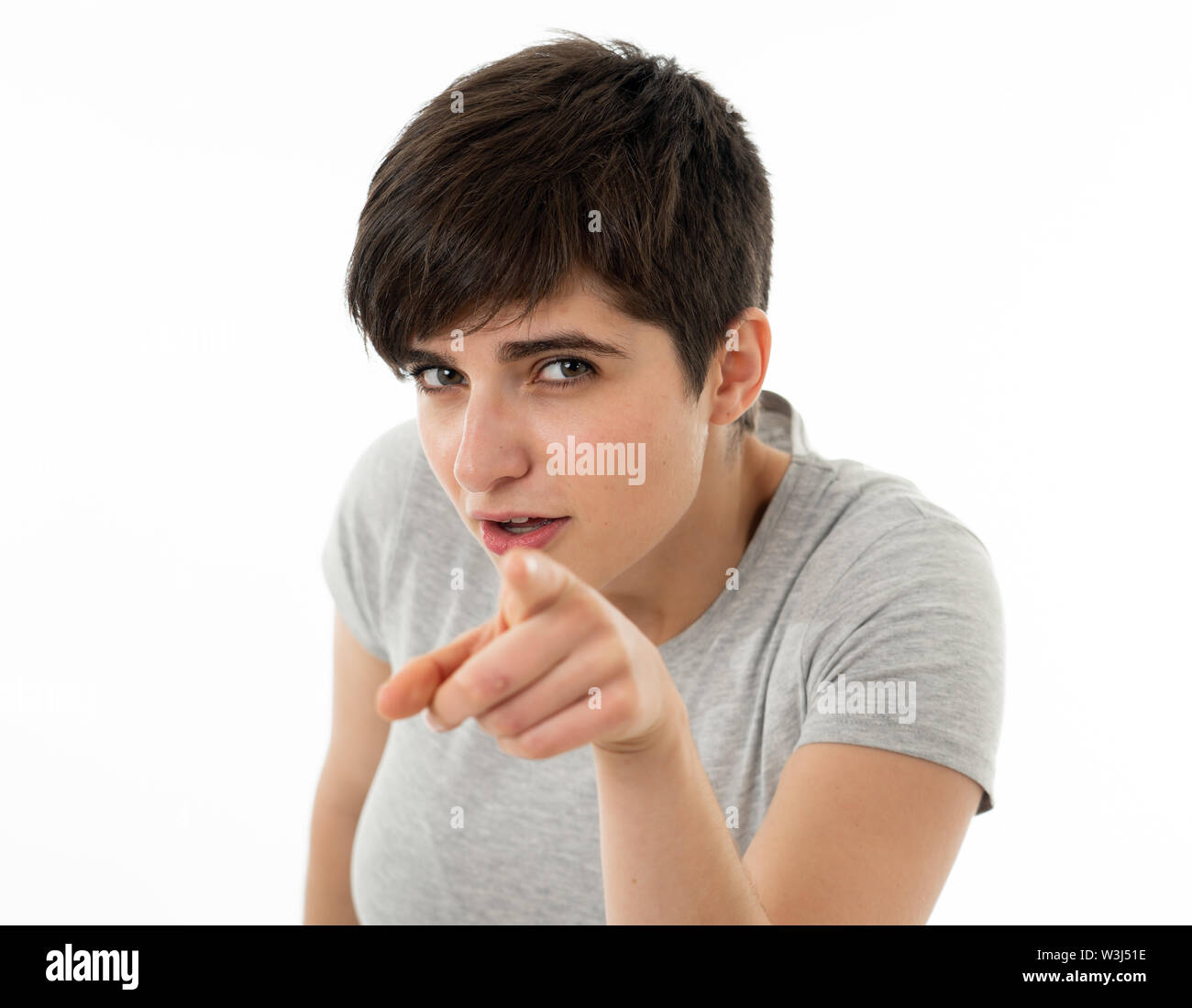 Close up portrait of scared and shocked young woman pointing at ...