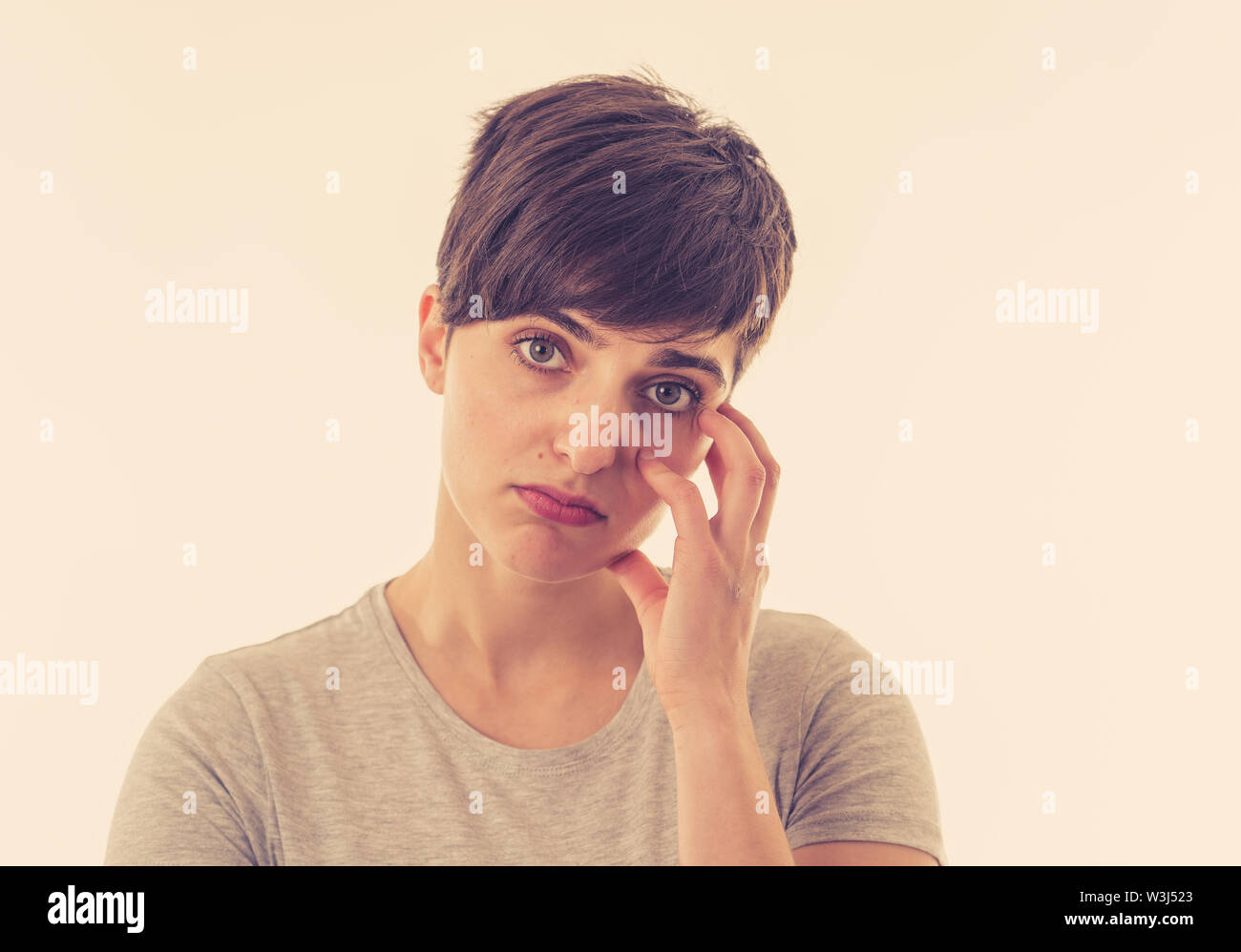 Close up portrait of beautiful young caucasian woman looking sad and ...