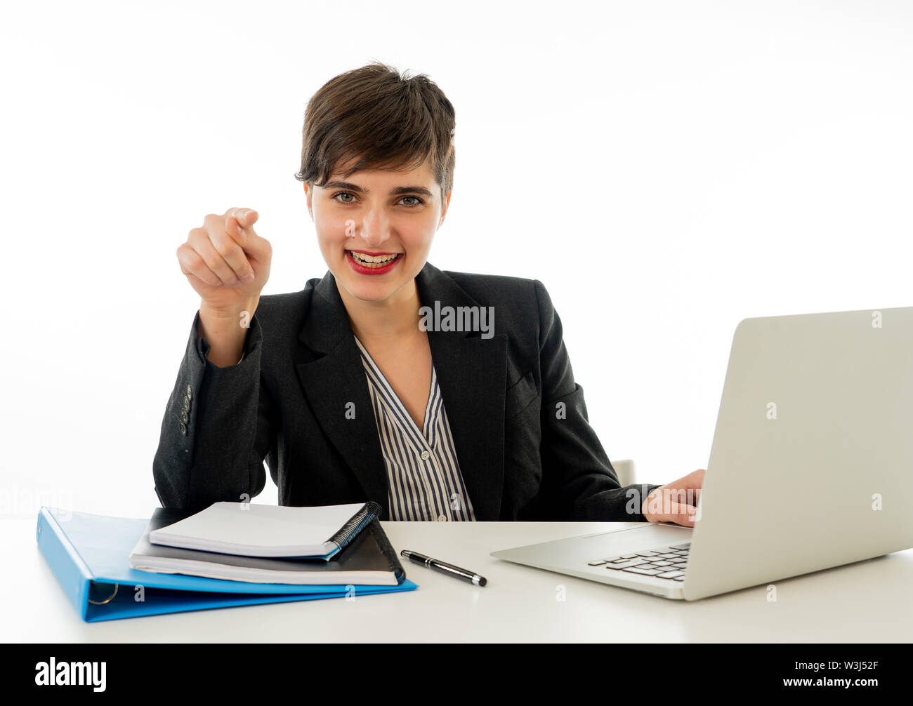 Happy, smiling and successful businesswoman working on computer laptop ...