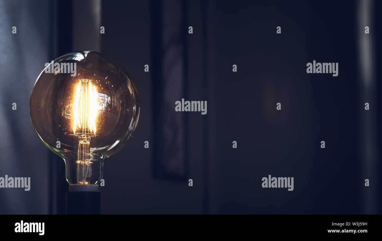 Retro light bulb on dark background with space. Lighting decor macro ...