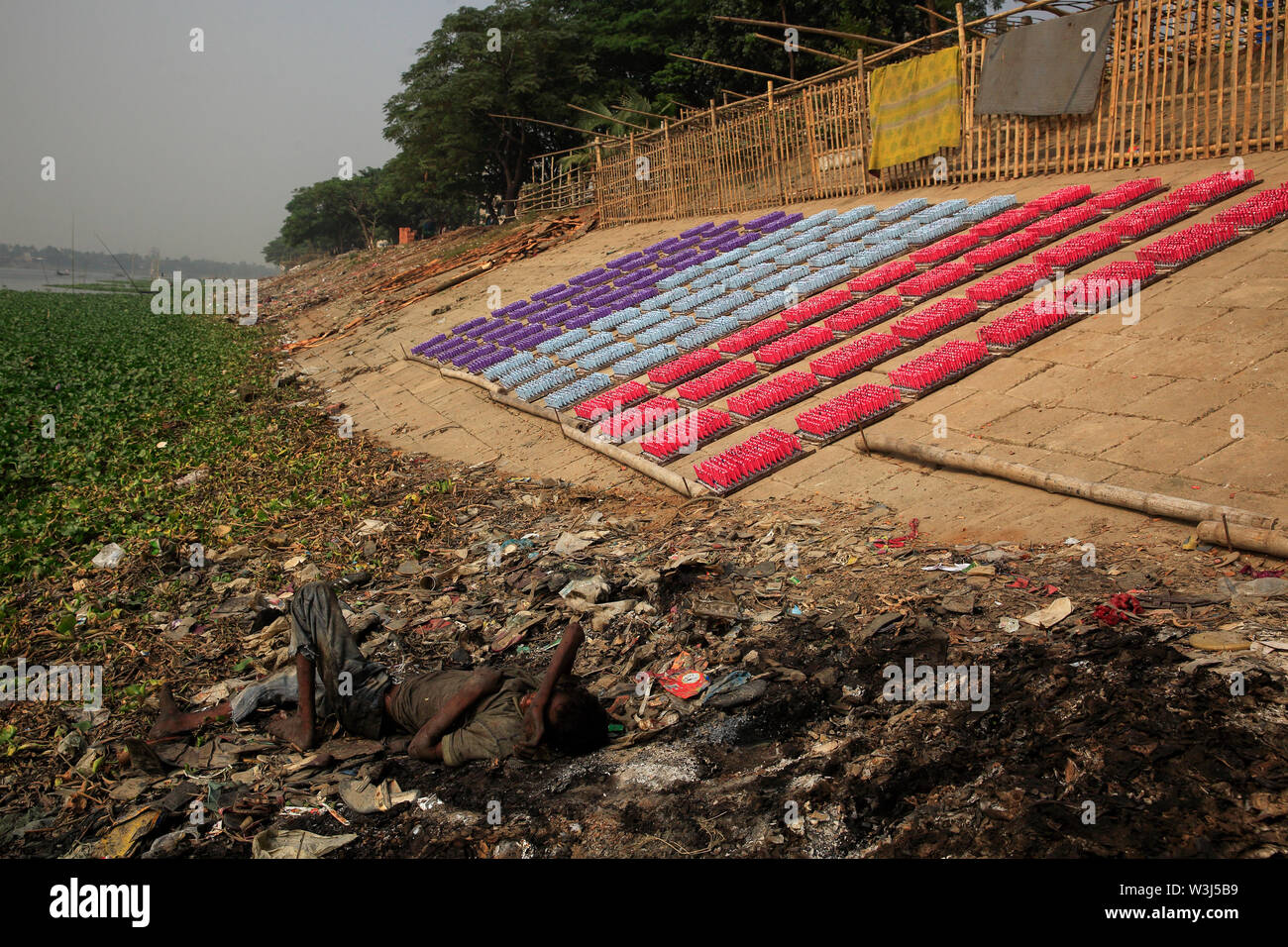 Drying racks of rubber balloon under the sun on the bank of Buriganga ...