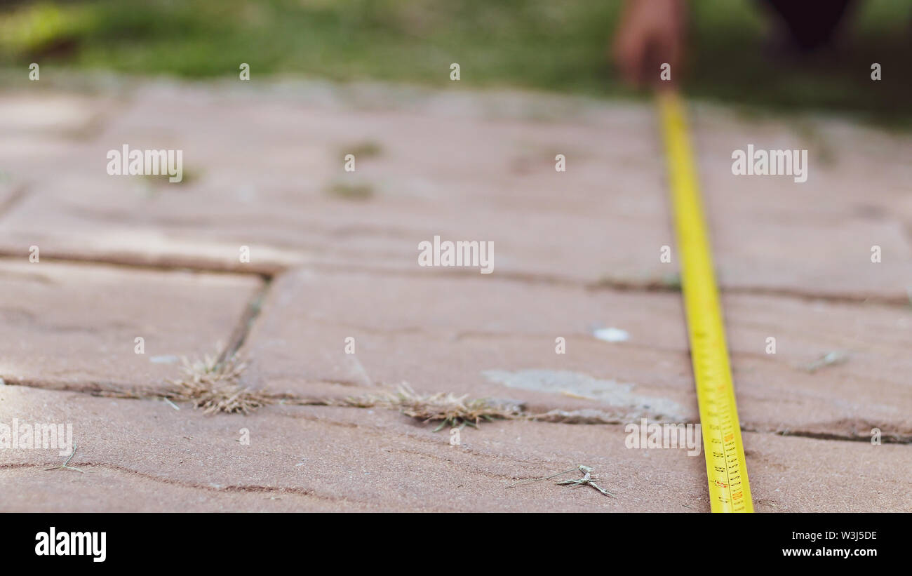 Tape measure road. Men's hands hold a measuring tape. Construction ...