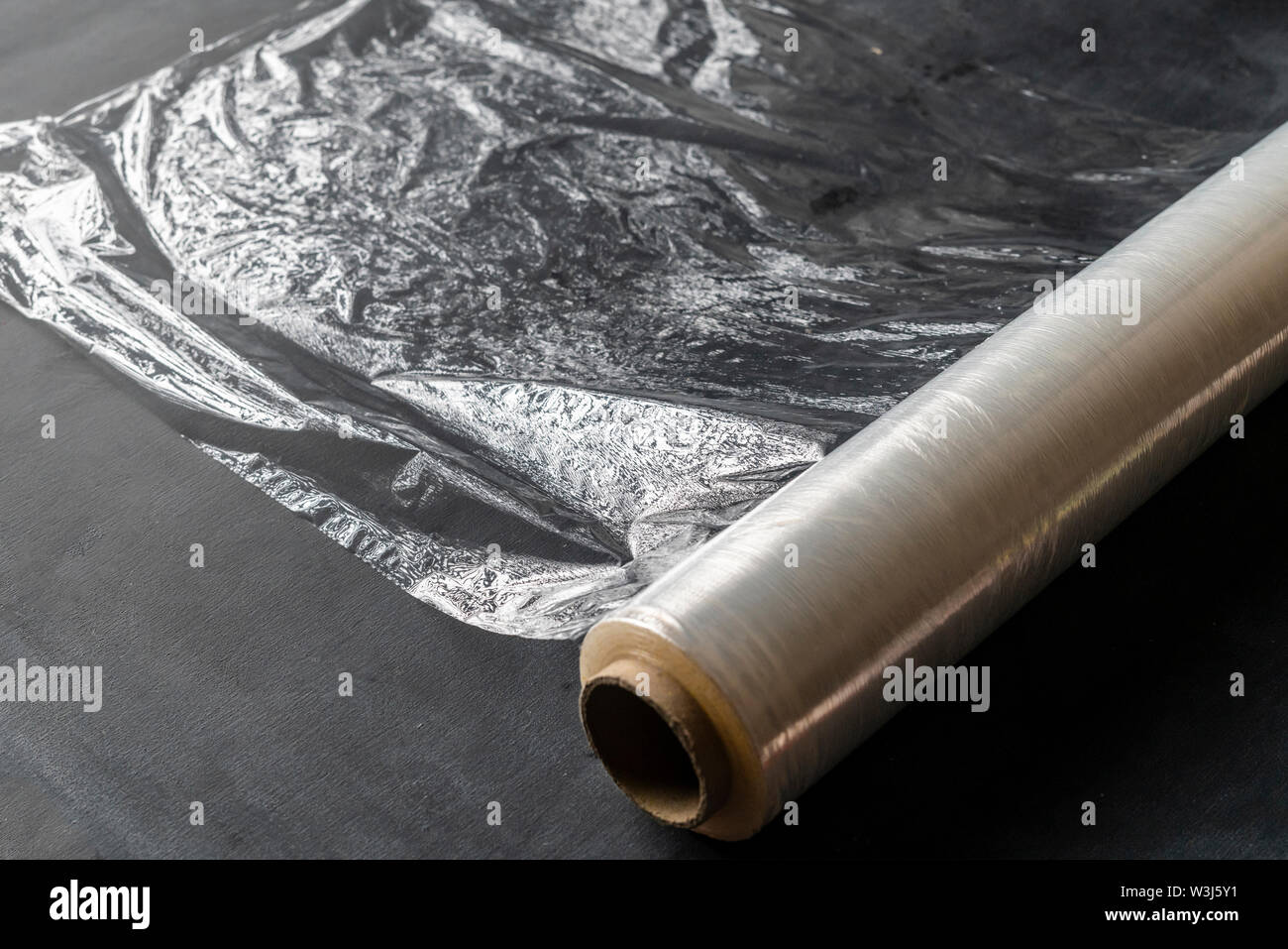 roll of wrapping stretch film for packing at colorful background ...