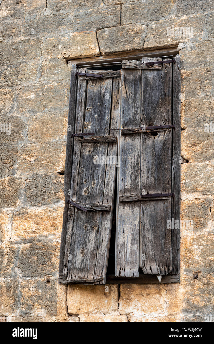 Old wood window cover on a stone house Stock Photo - Alamy
